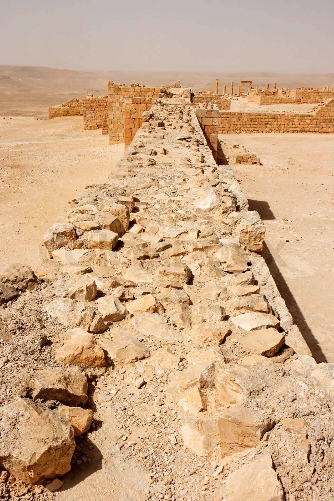 Wall of the ancient fortress in the desert during sandstorm | Stock ...
