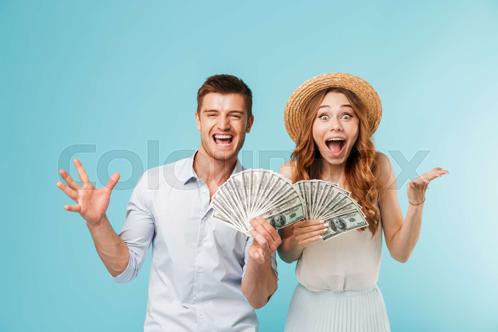 Screaming caucasian loving couple holding money. | Stock image | Colourbox