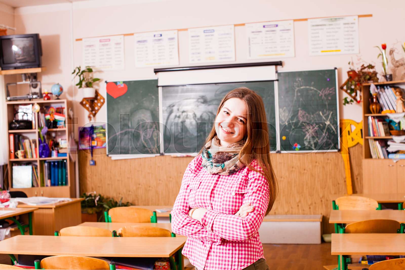 Teachear stands in classroom | Stock image | Colourbox