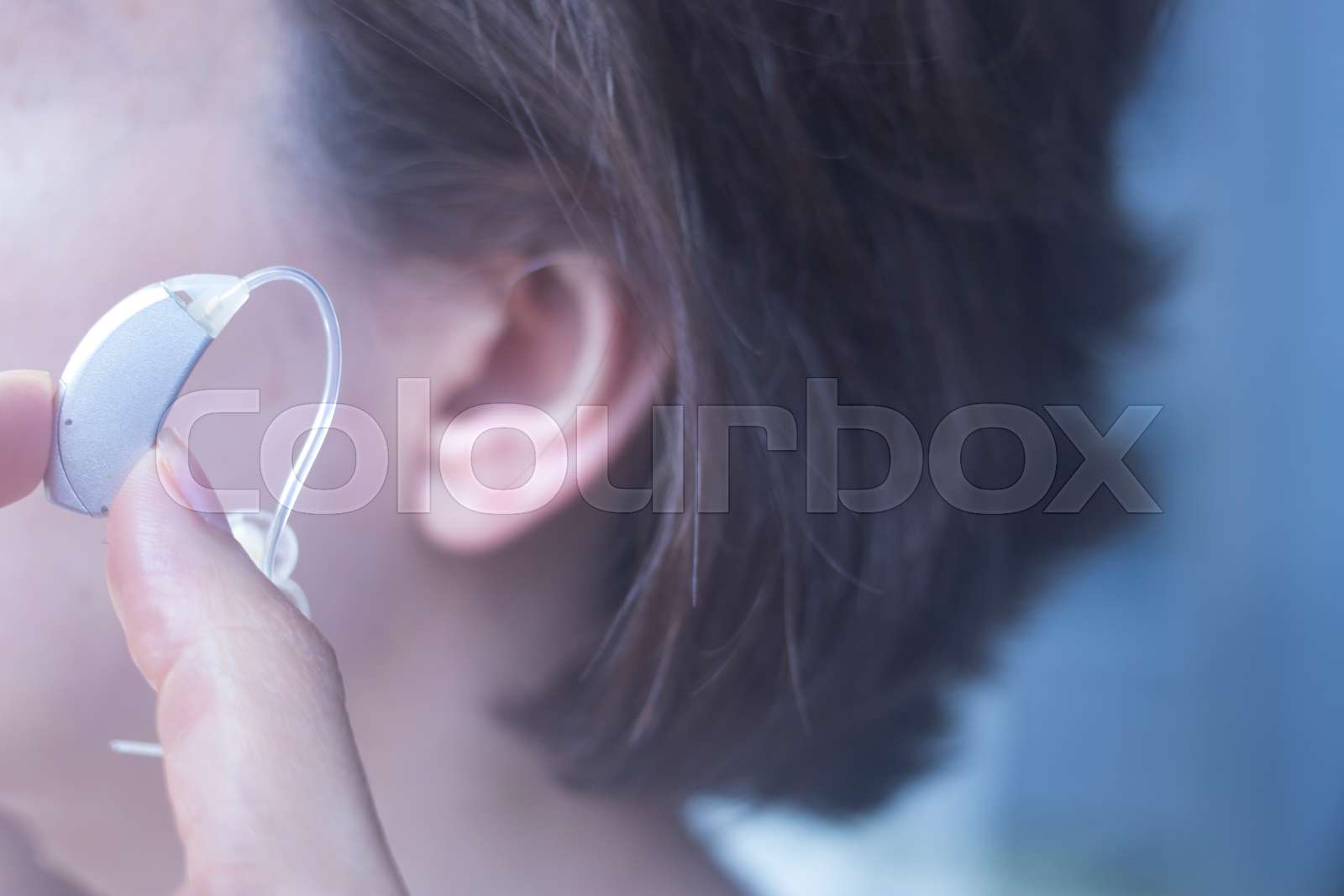 Deaf woman hearing aid ear | Stock image | Colourbox