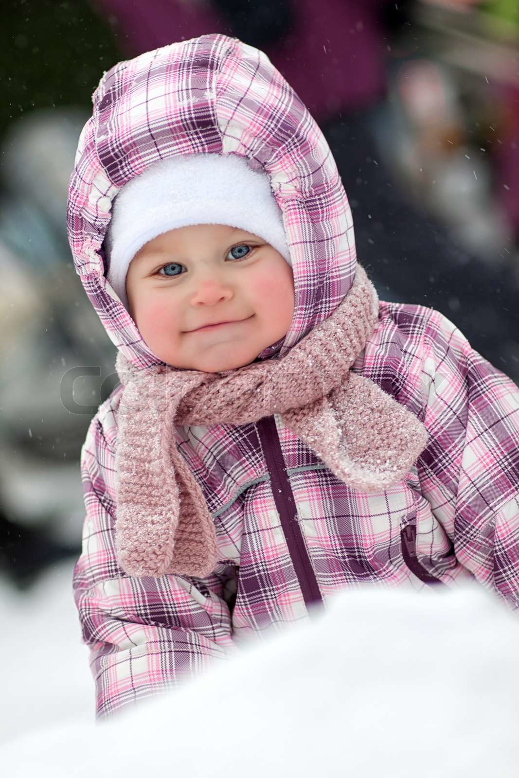Cute baby is smiling outdoor snow winter | Stock image | Colourbox