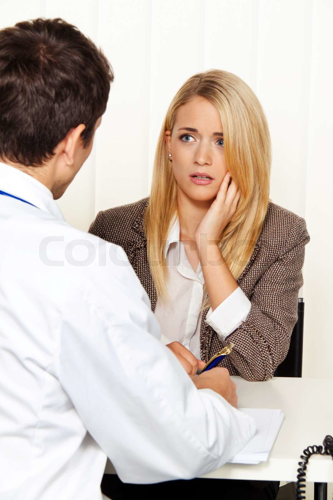 patient and doctor talking to a doctor's office | Stock image | Colourbox