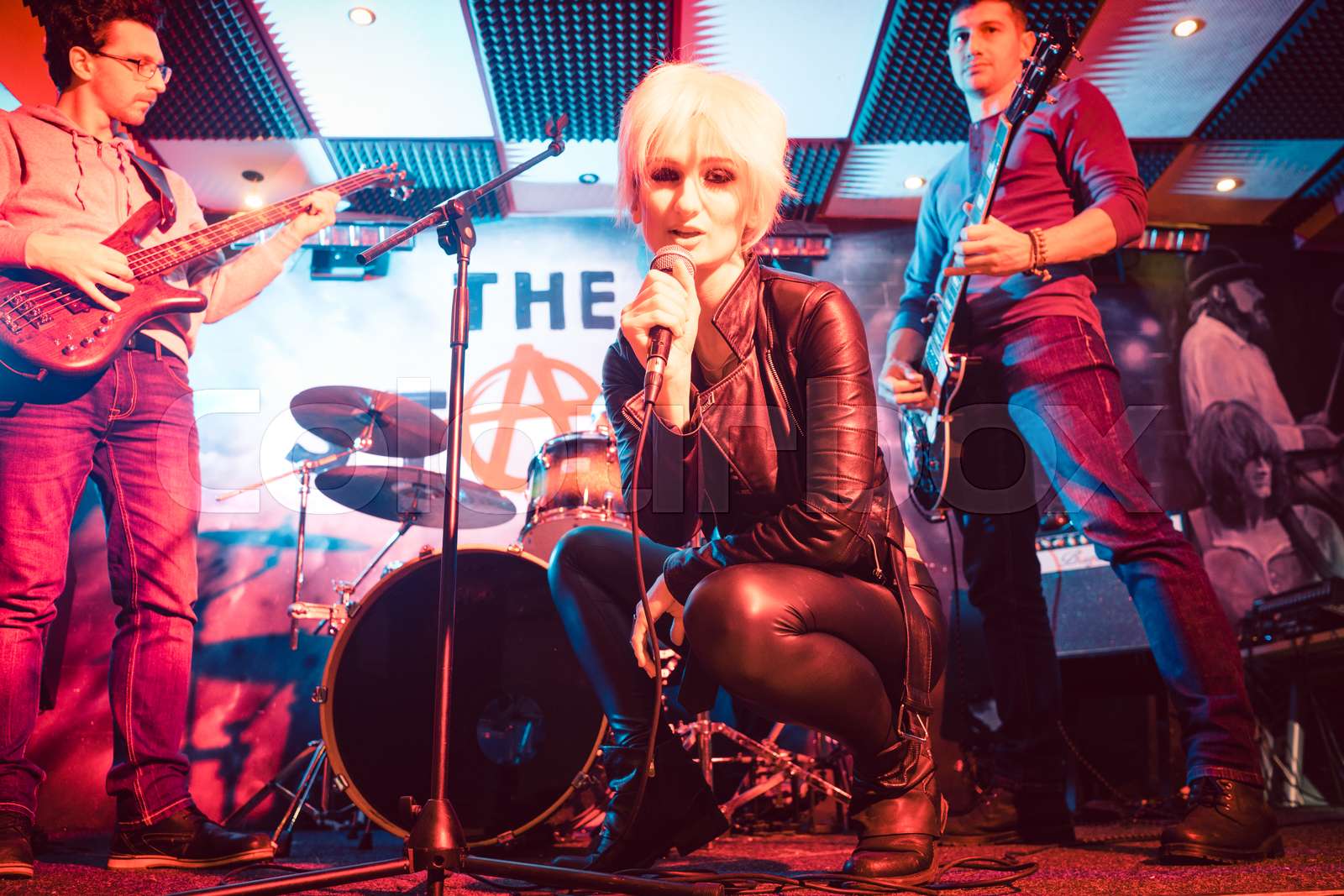 Band during gig making rock music on stage | Stock image | Colourbox