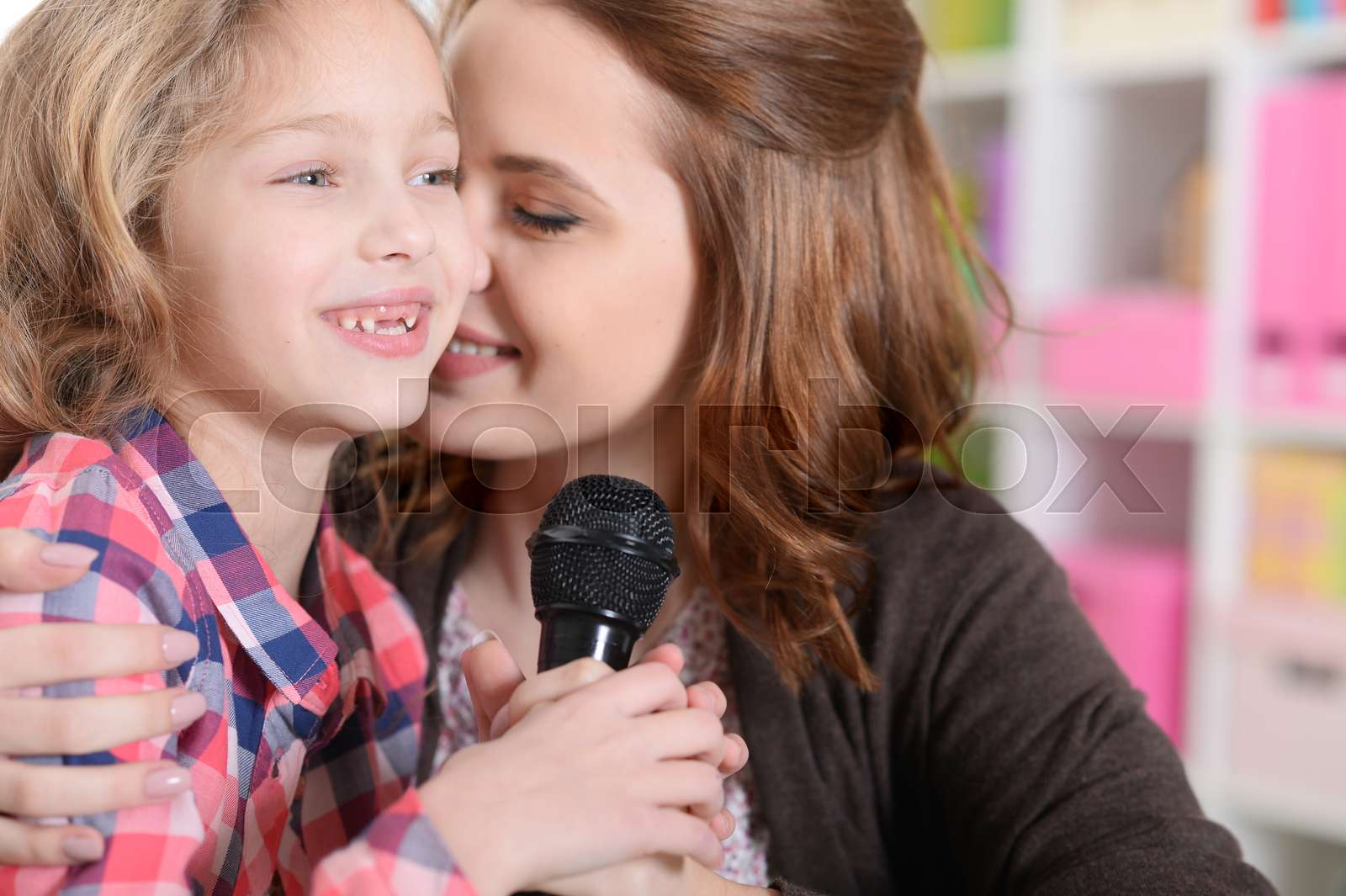 mother and daughter singing karaoke | Stock image | Colourbox