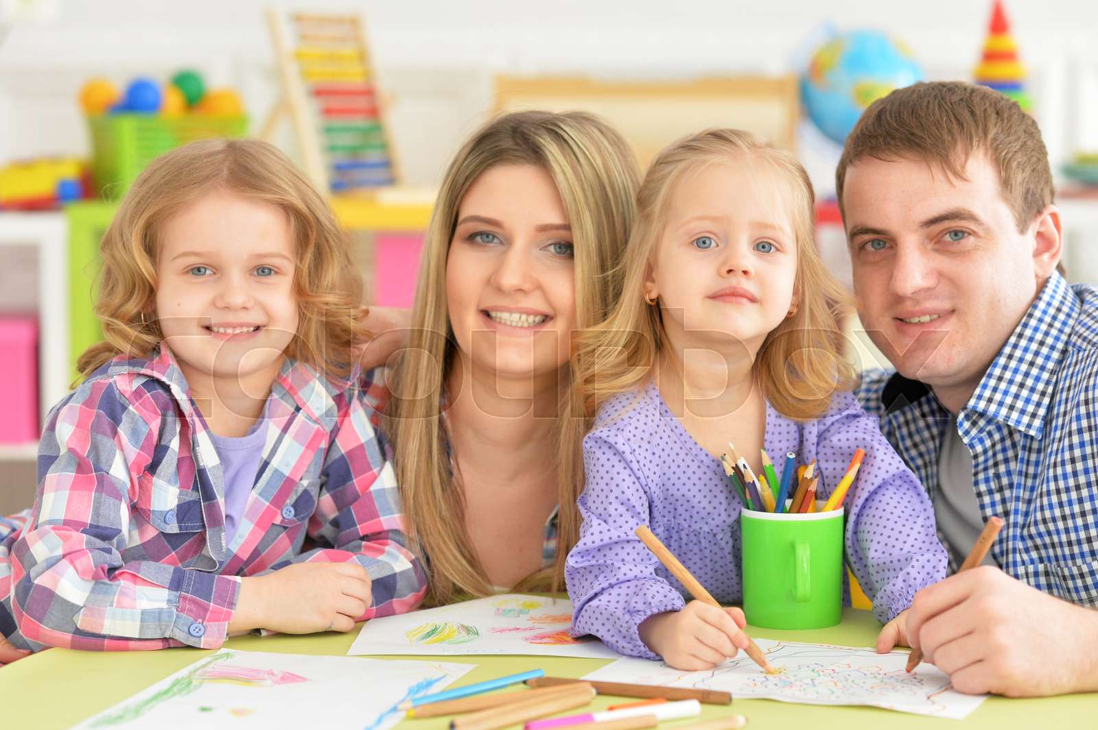 parents with daughters drawing with pencils | Stock image | Colourbox