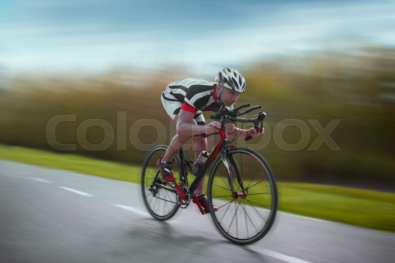 Cyclist rides on bicycle, speed effect, side view | Stock image | Colourbox
