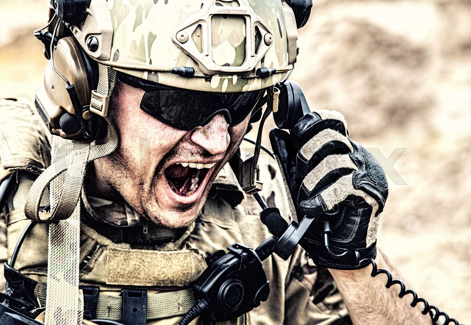 Soldier communicating with command during battle | Stock image | Colourbox
