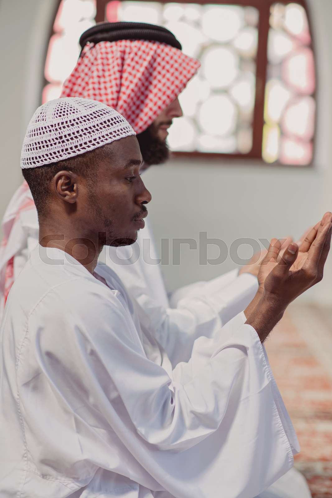 Two religious muslim man praying together inside the mosque | Stock ...
