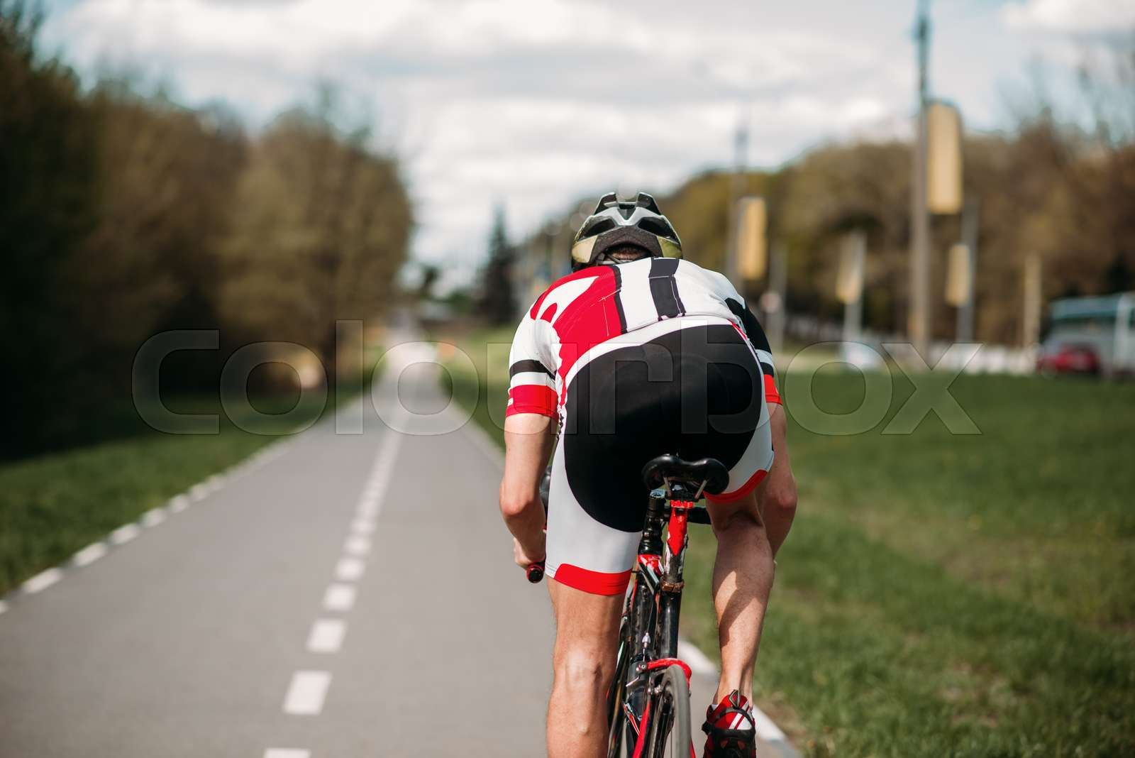 Cyclist rides on bicycle, side view | Stock image | Colourbox