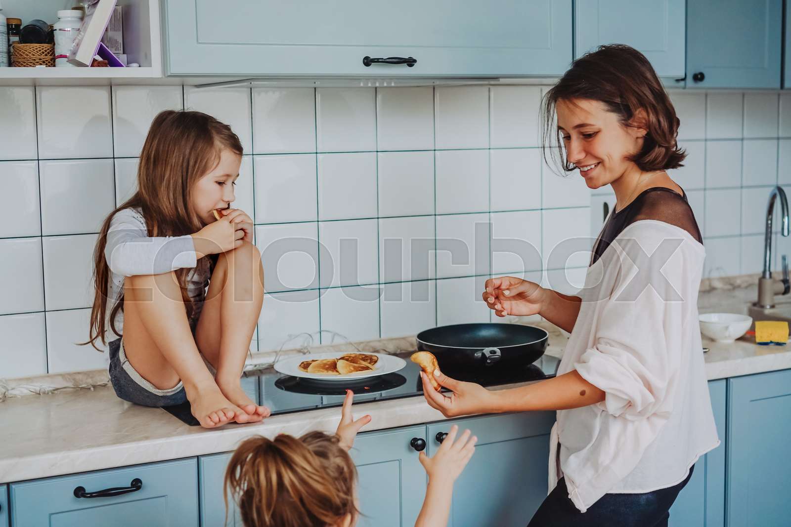 happy family cook together in the kitchen | Stock image | Colourbox