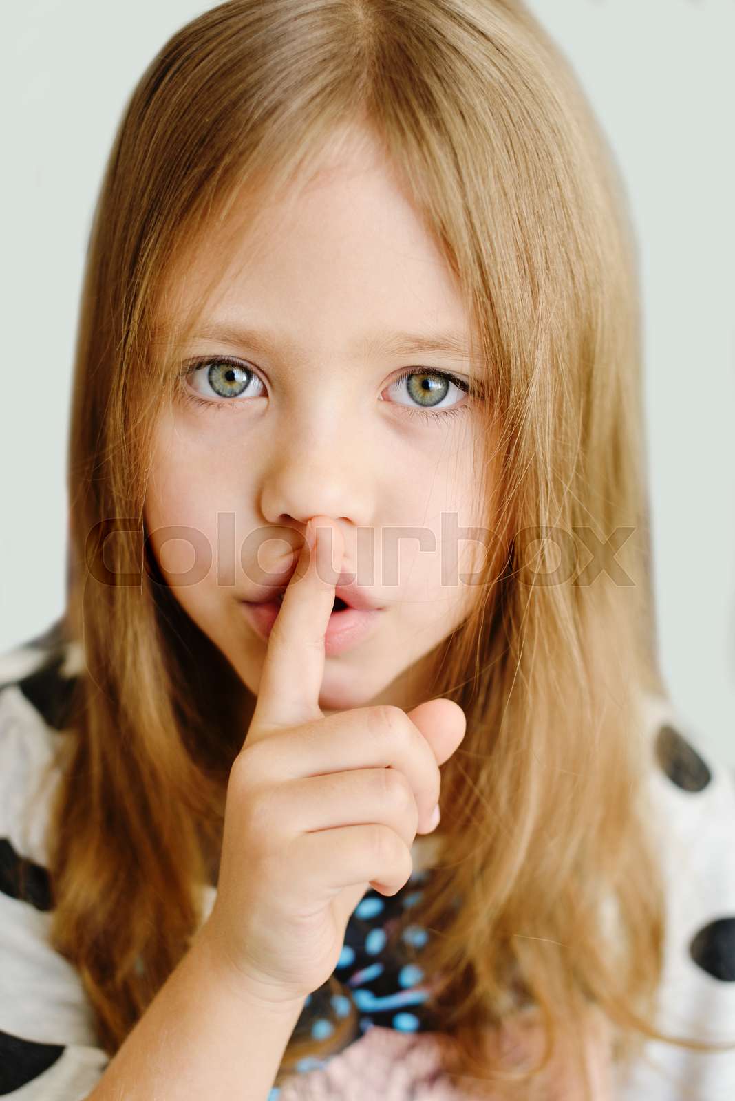 girl placing finger on lips | Stock image | Colourbox