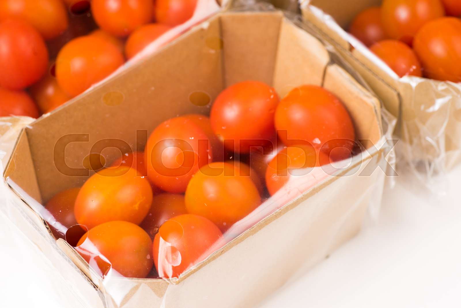 ripe cherry tomatoes packages in box and plastic | Stock image | Colourbox