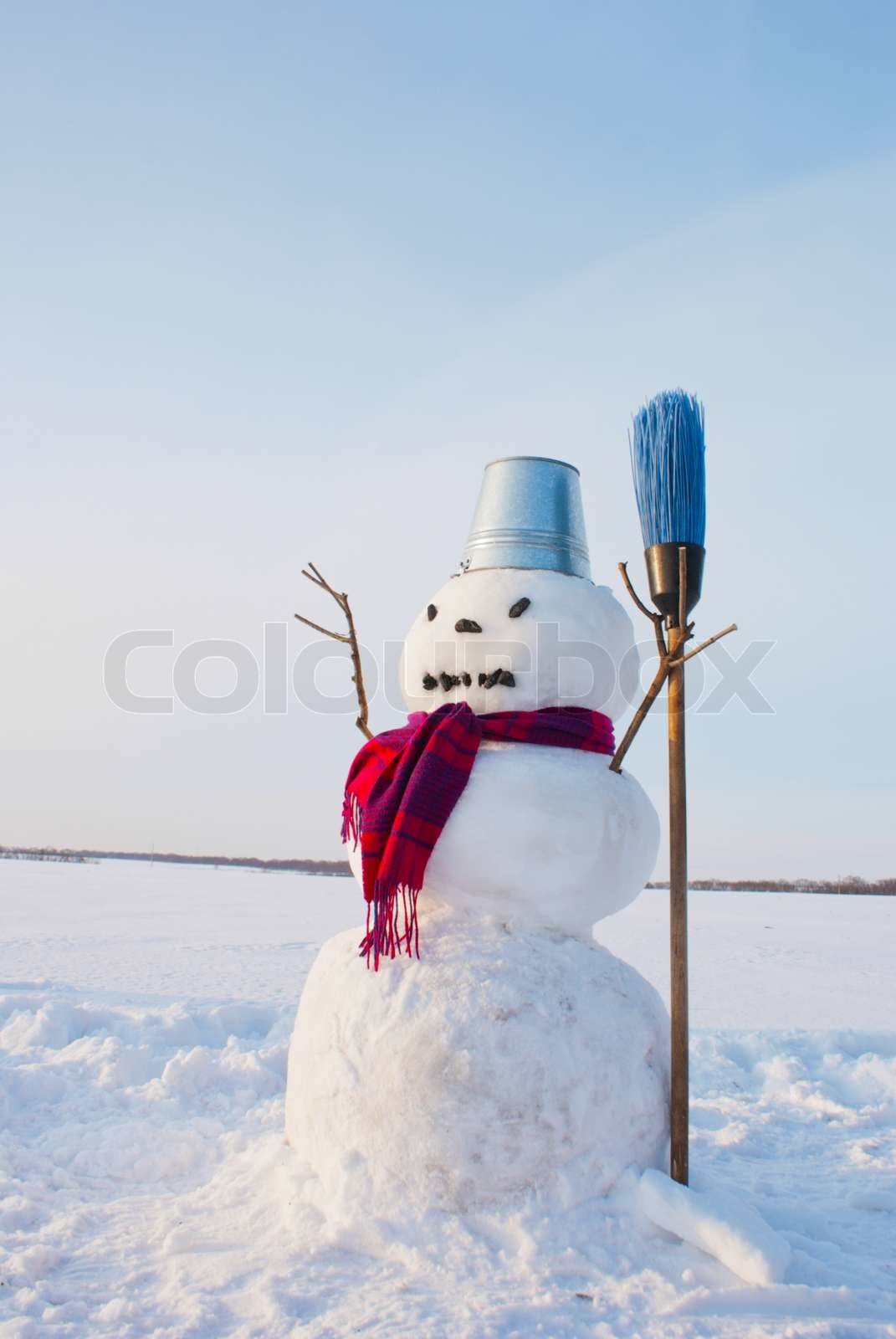 Lonely snowman at a snowy field at winter time | Stock image | Colourbox
