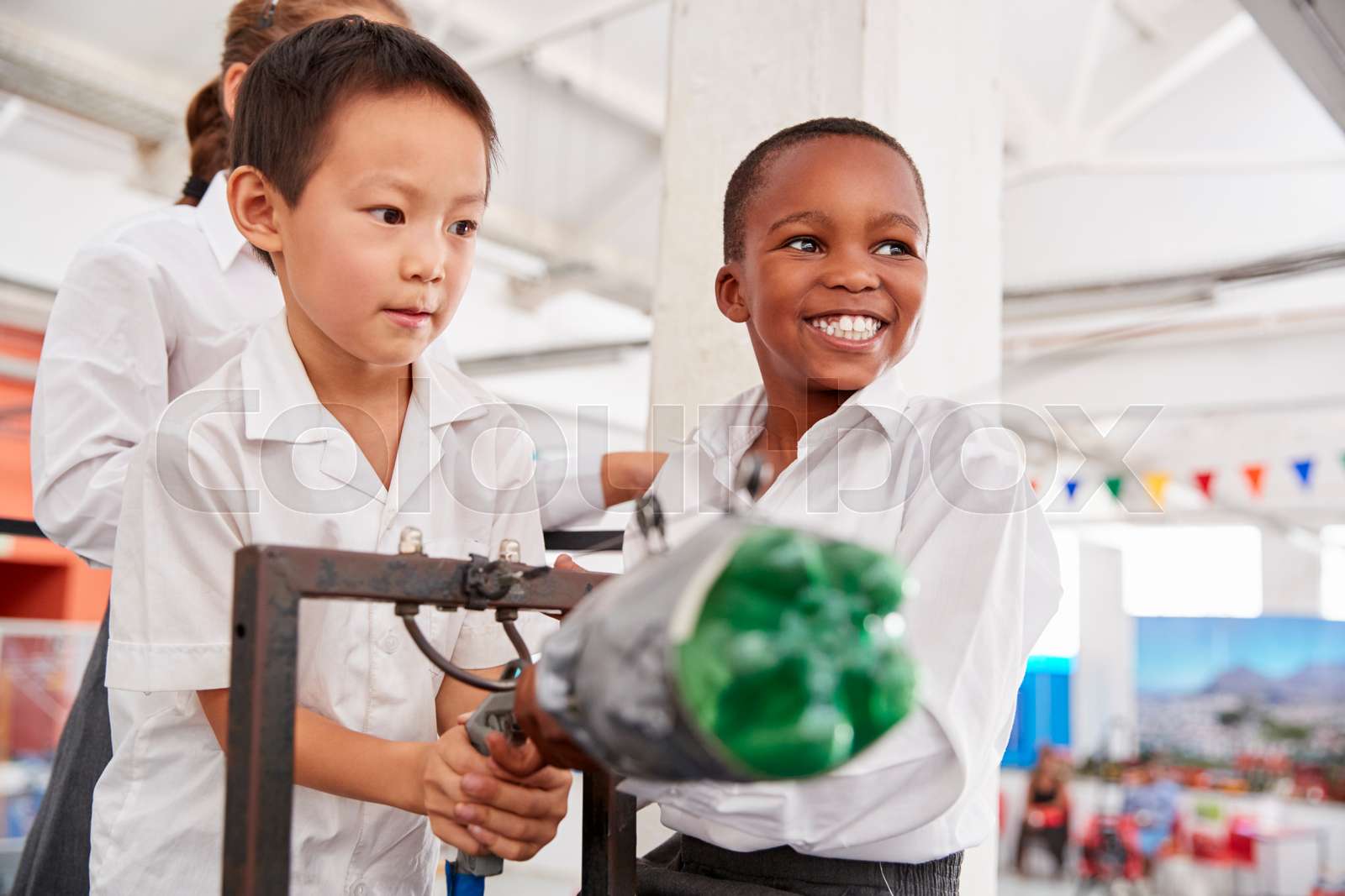 Two schoolboys using air pressure rocket at a science centre | Stock ...