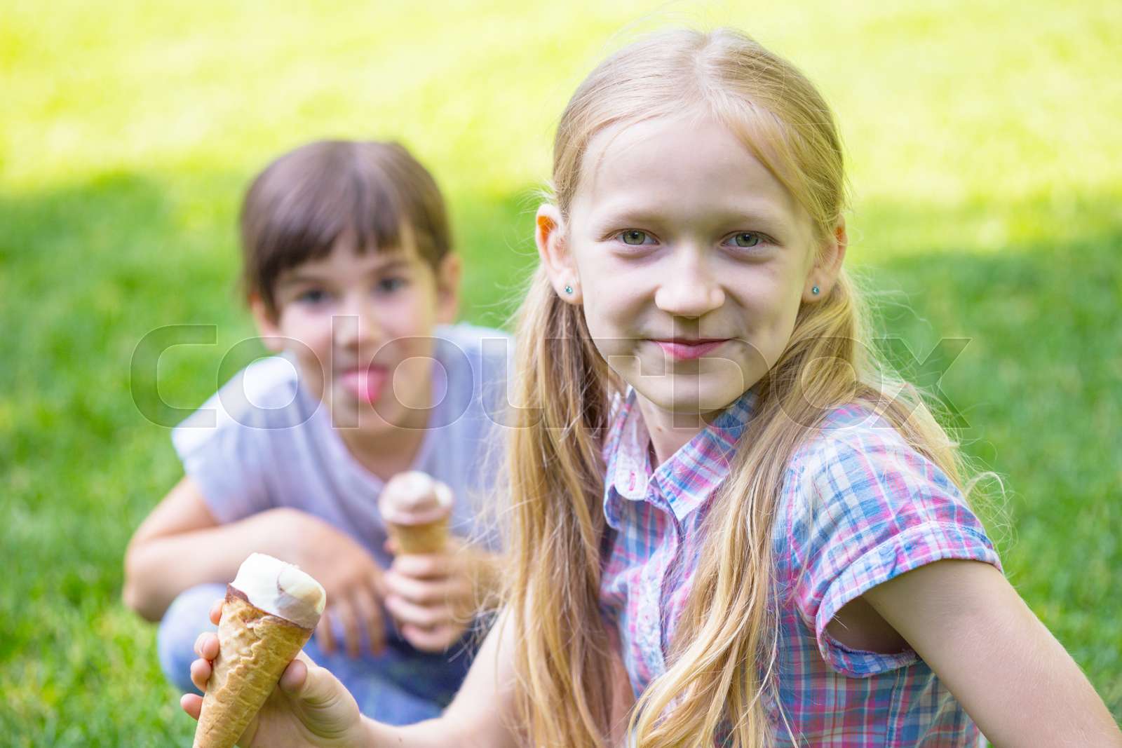 little girl girlfriend on the lawn | Stock image | Colourbox