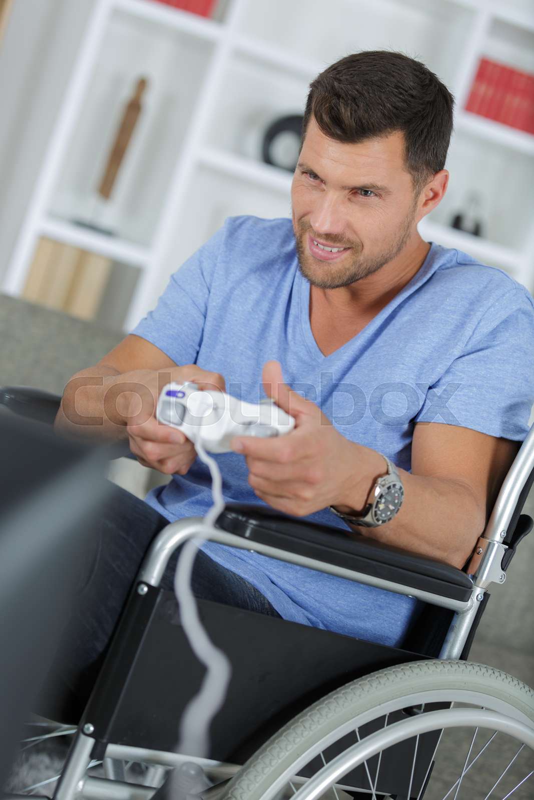disabled man playing video games | Stock image | Colourbox