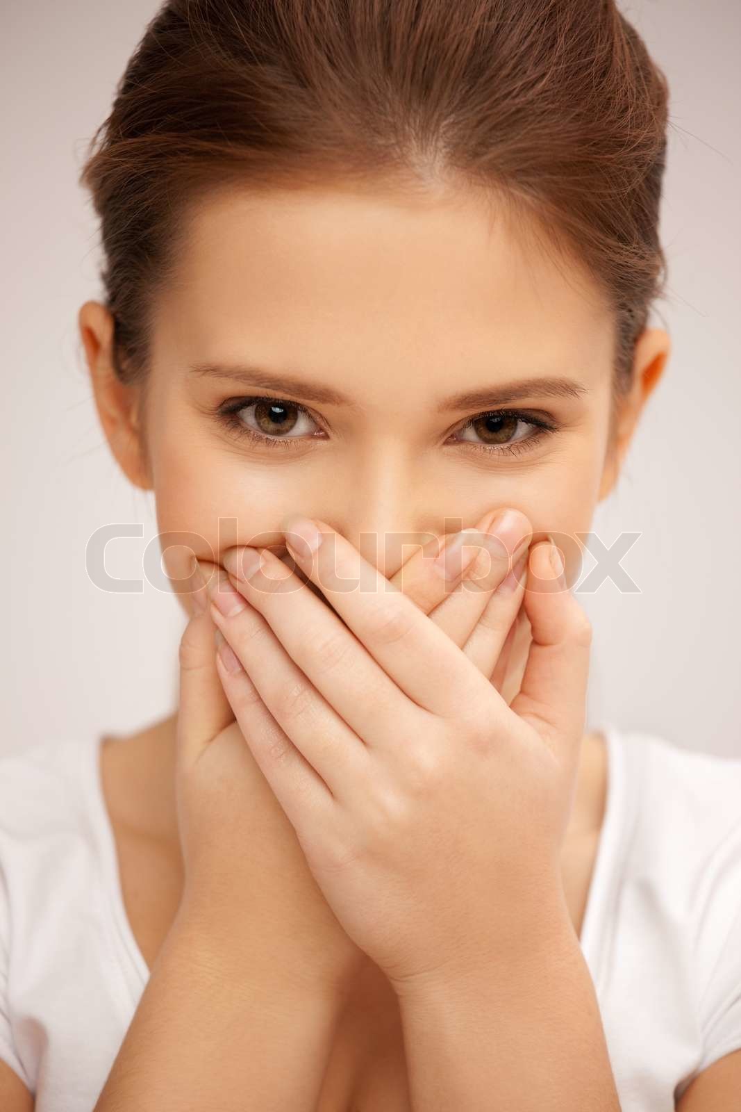 bright closeup picture of woman with hand over mouth | Stock image ...