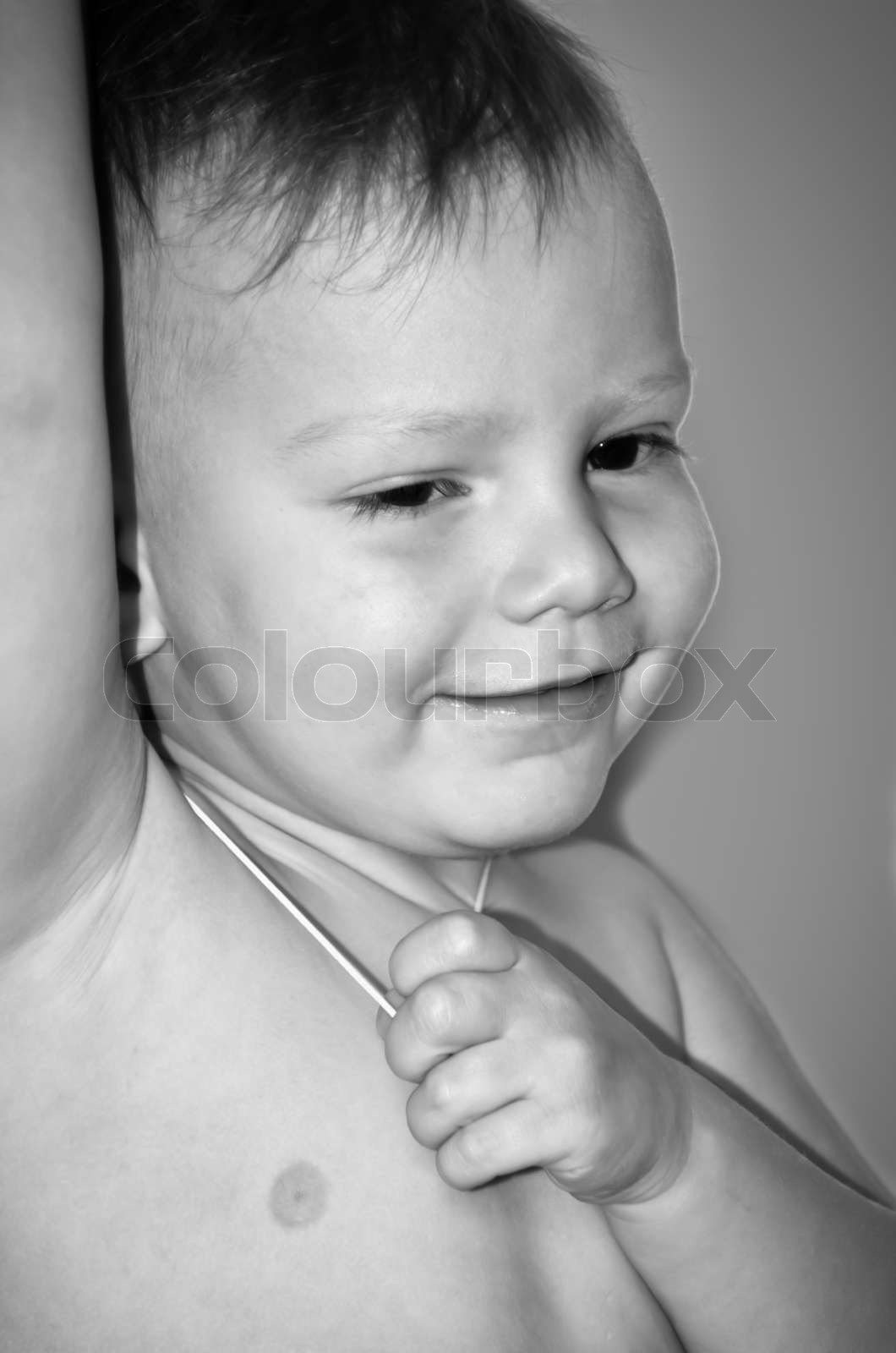 The little boy smiles and hesitates | Stock image | Colourbox