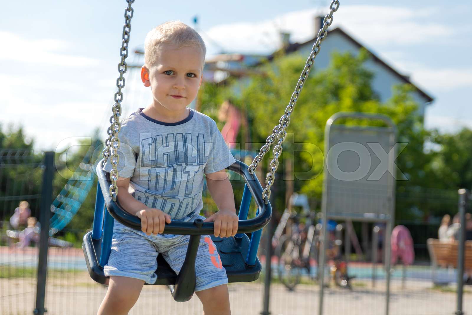 Happy little boy on children playground. Child on a swing | Stock image ...