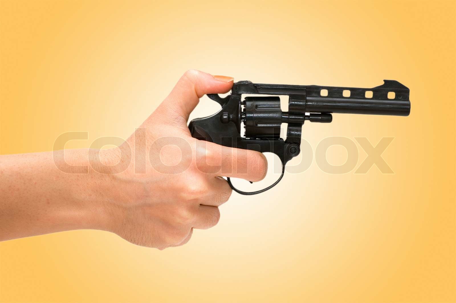 Hand holding revolver isolated on the white | Stock image | Colourbox