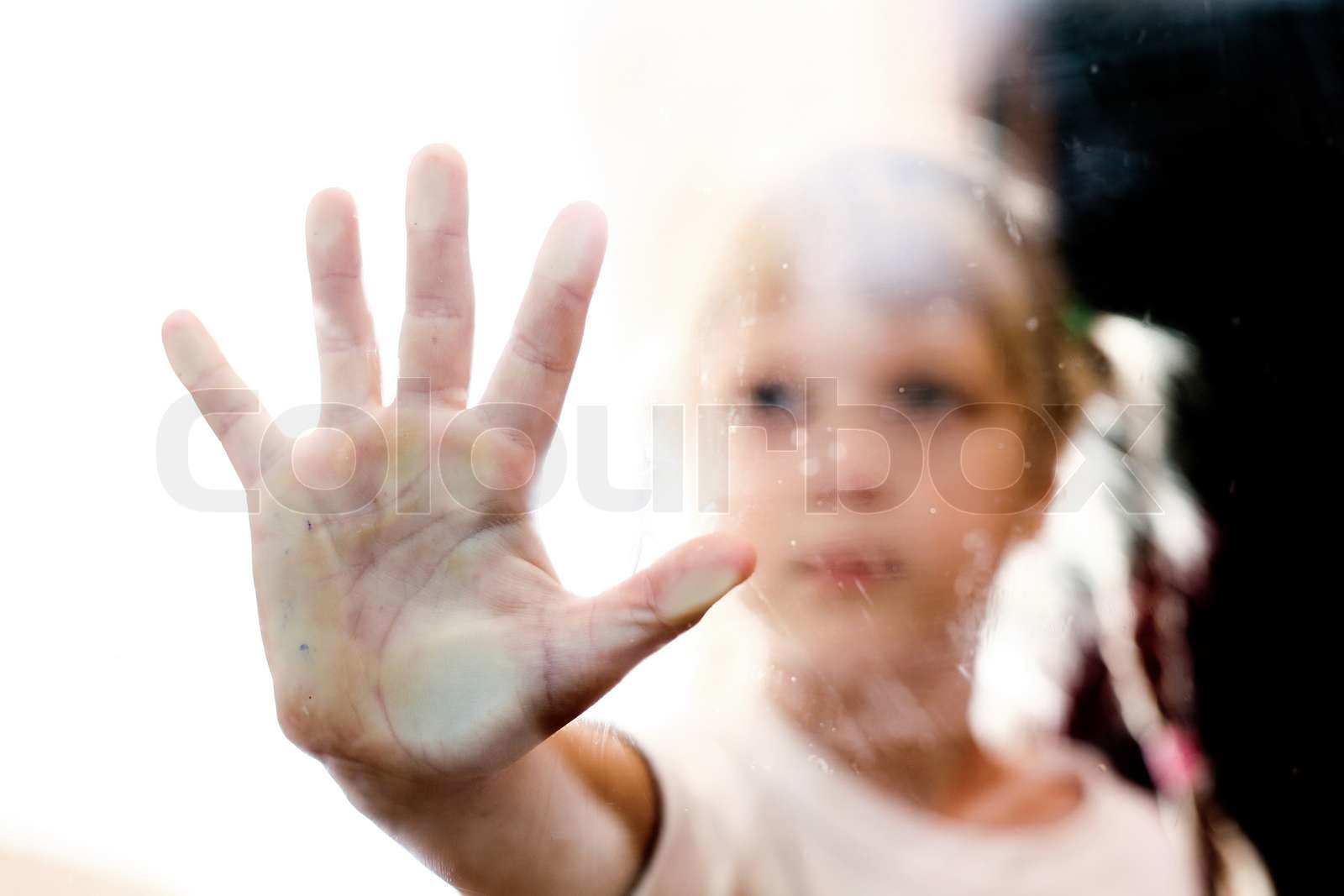 An image of child stands outside the window | Stock image | Colourbox