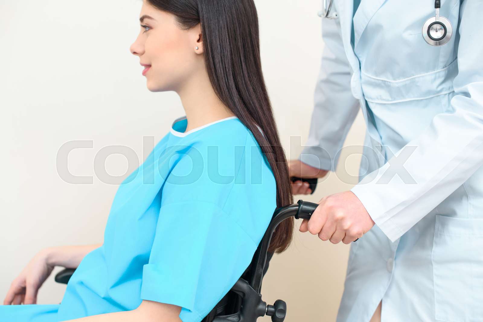 cropped shot of obstetrician gynecologist riding pregnant woman on ...