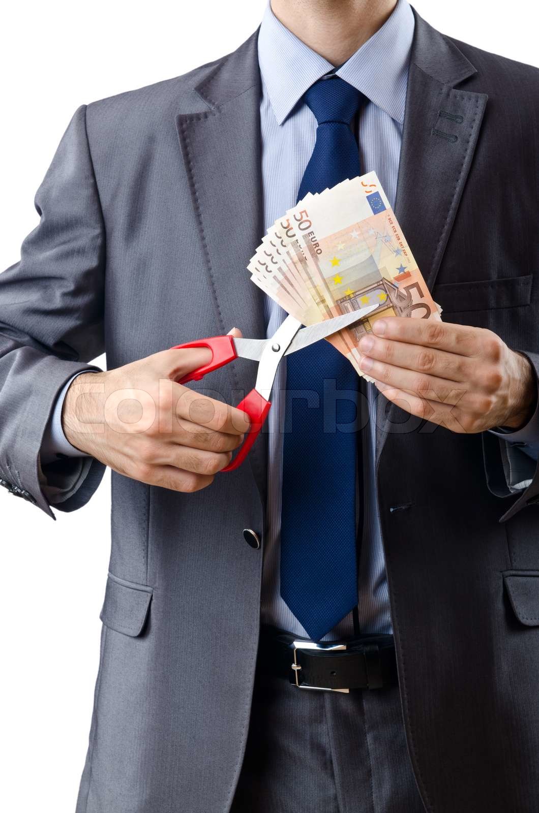 Man cutting money on white | Stock image | Colourbox