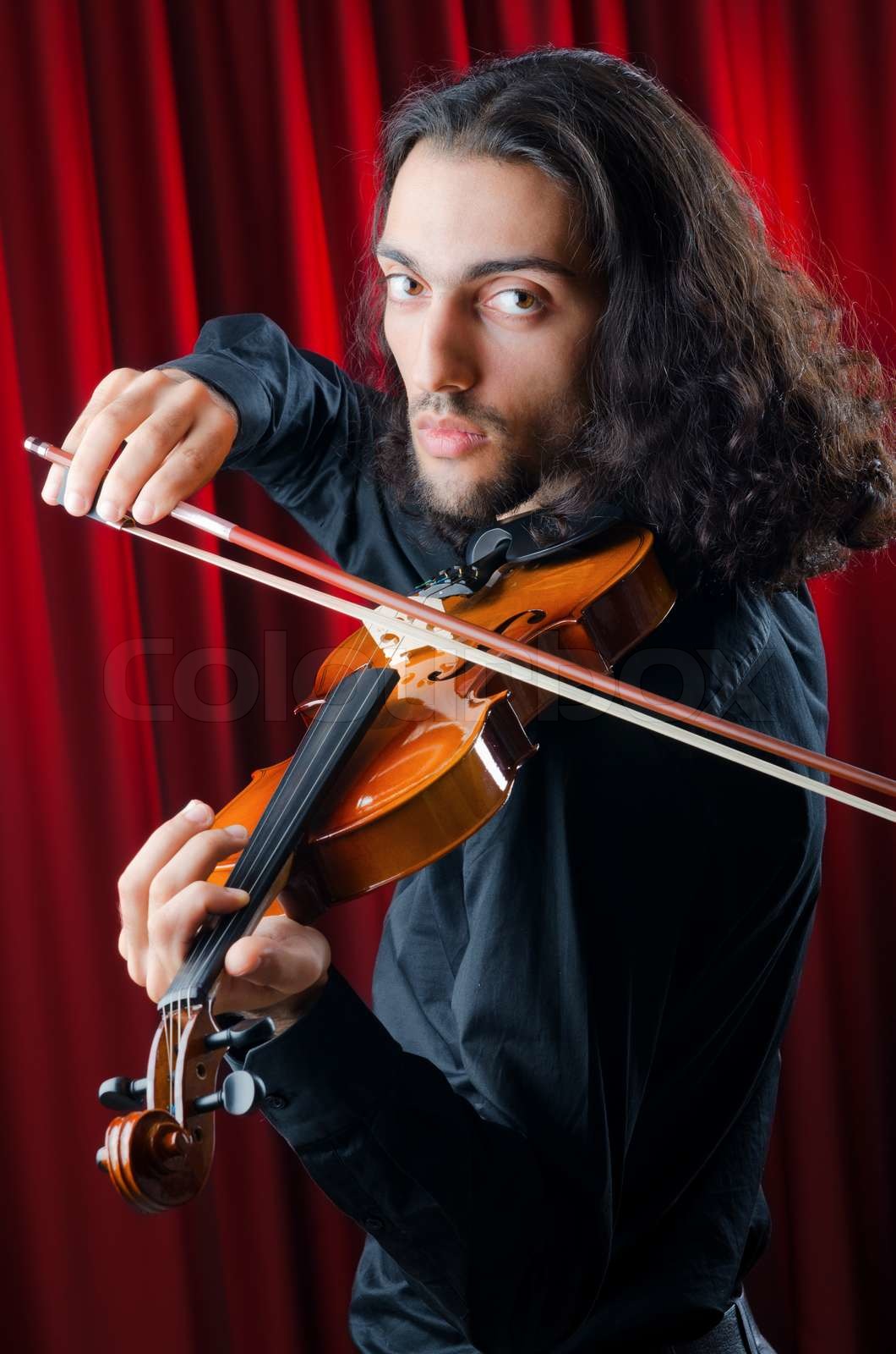 Violin player playing the intstrument | Stock image | Colourbox