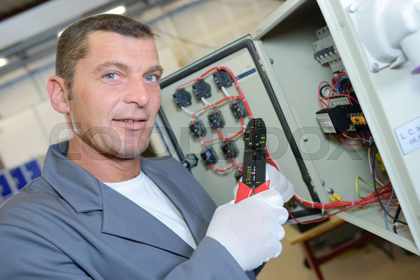Electrician using wire strippers | Stock image | Colourbox