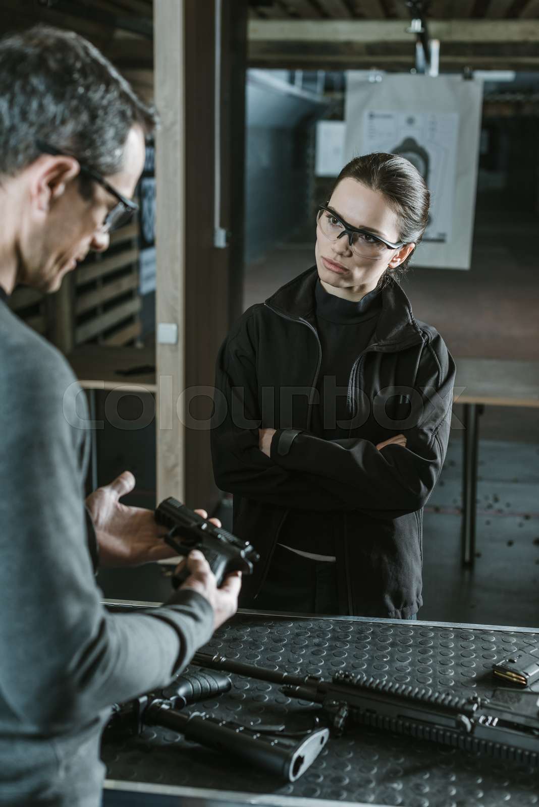 instructor holding gun in shooting range | Stock image | Colourbox