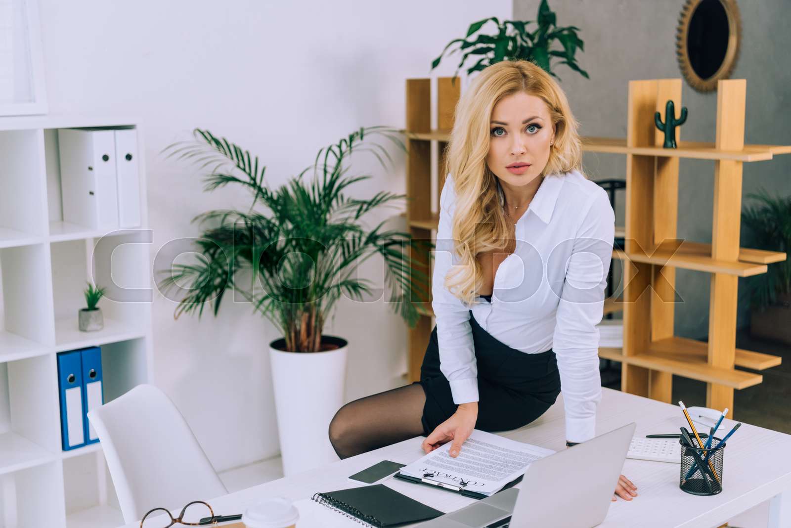 woman sitting on table and looking at camera | Stock image | Colourbox