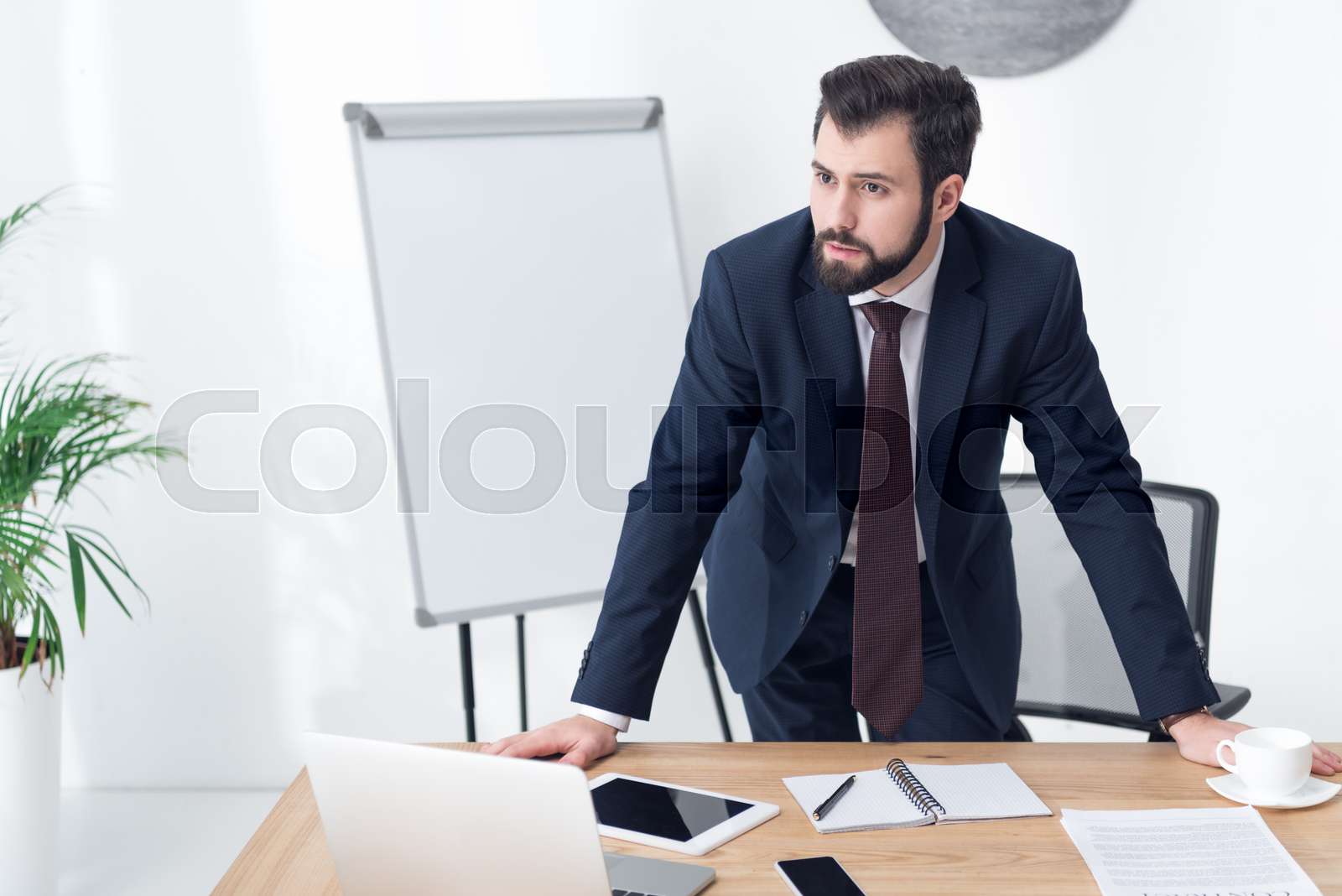 businessman looking away at workplace in office | Stock image | Colourbox