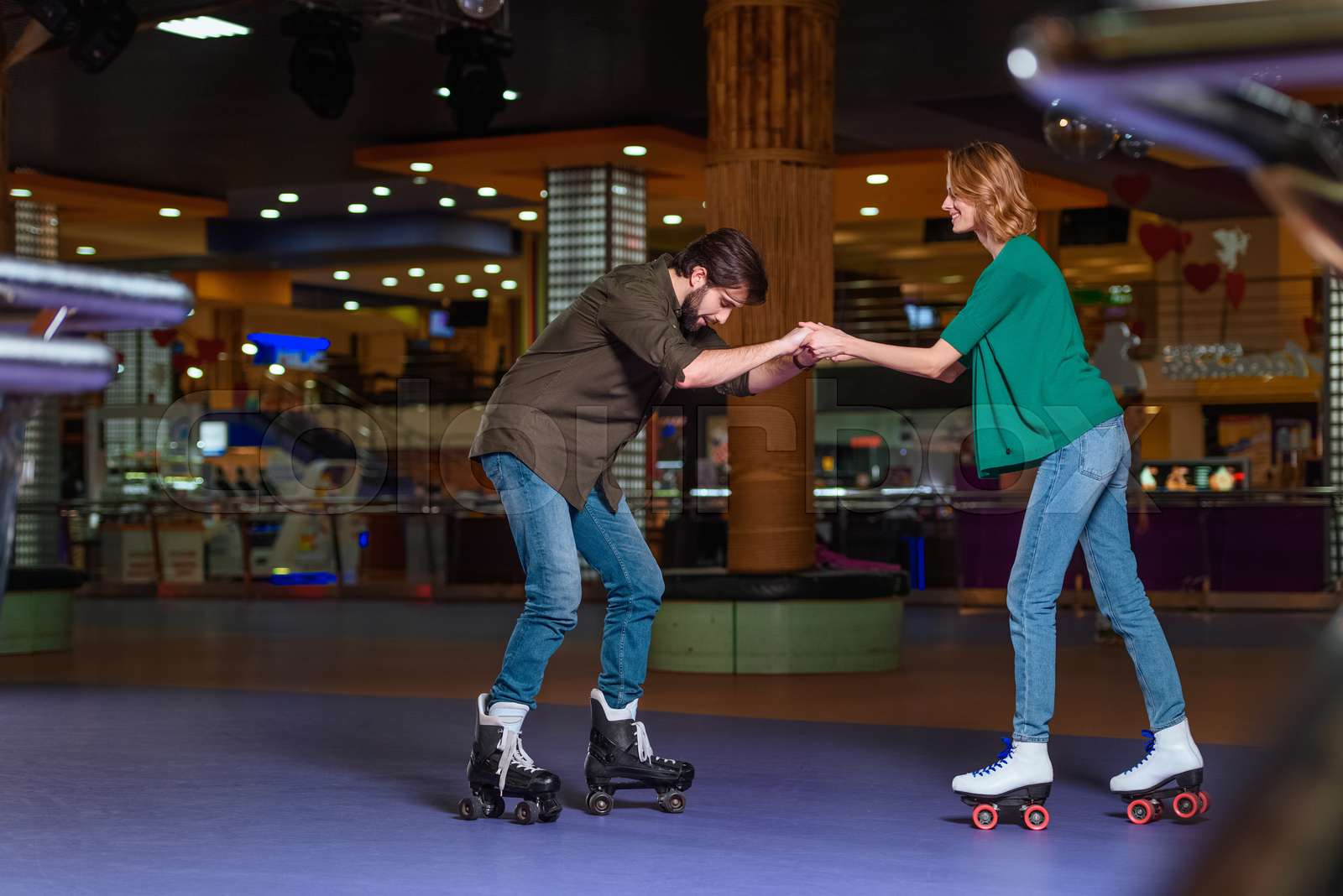young couple skating together on roller rink | Stock image | Colourbox