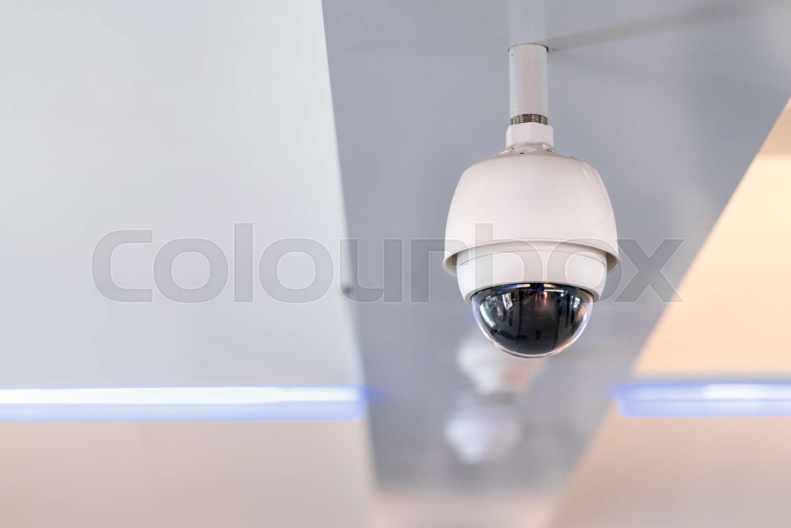 CCTV security camera on ceiling operating inside the building for crime ...