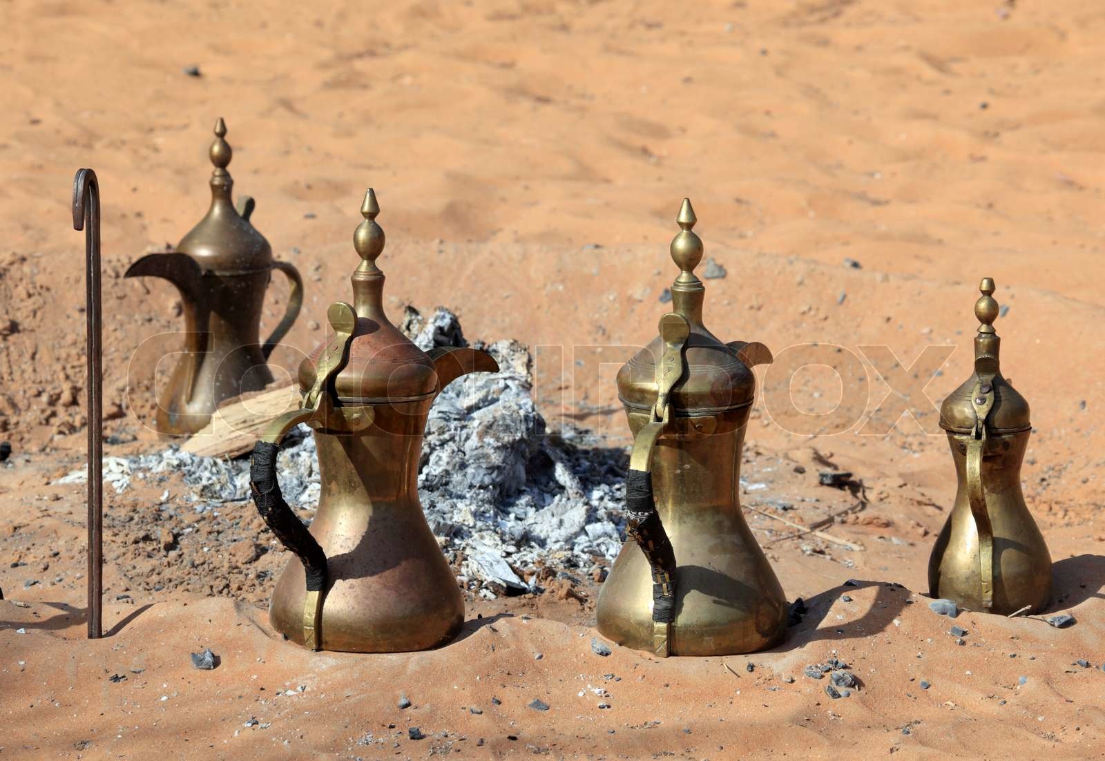 Traditional Arabic coffee pots at fireplace in the desert | Stock image ...