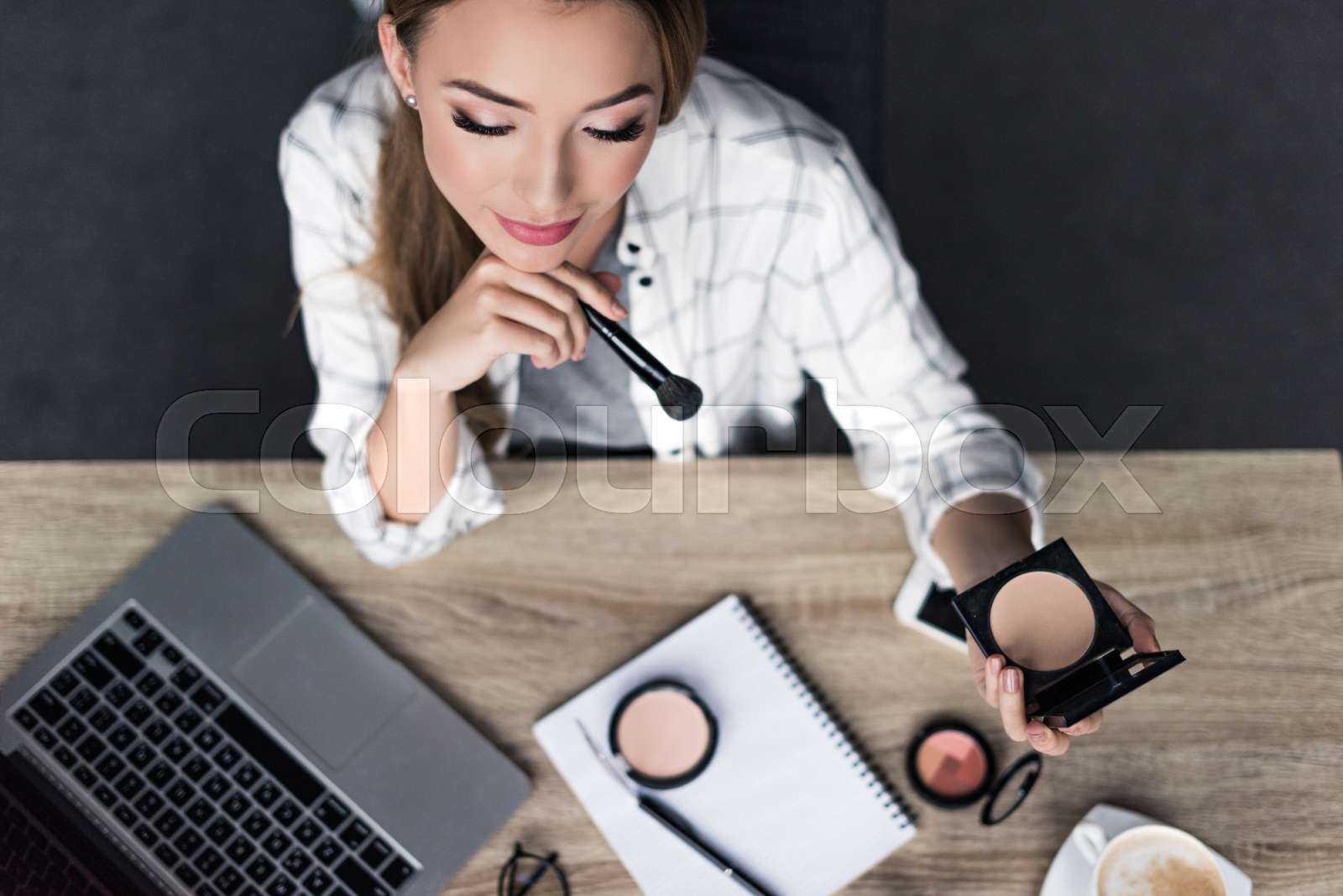 woman doing makeup at workplace | Stock image | Colourbox