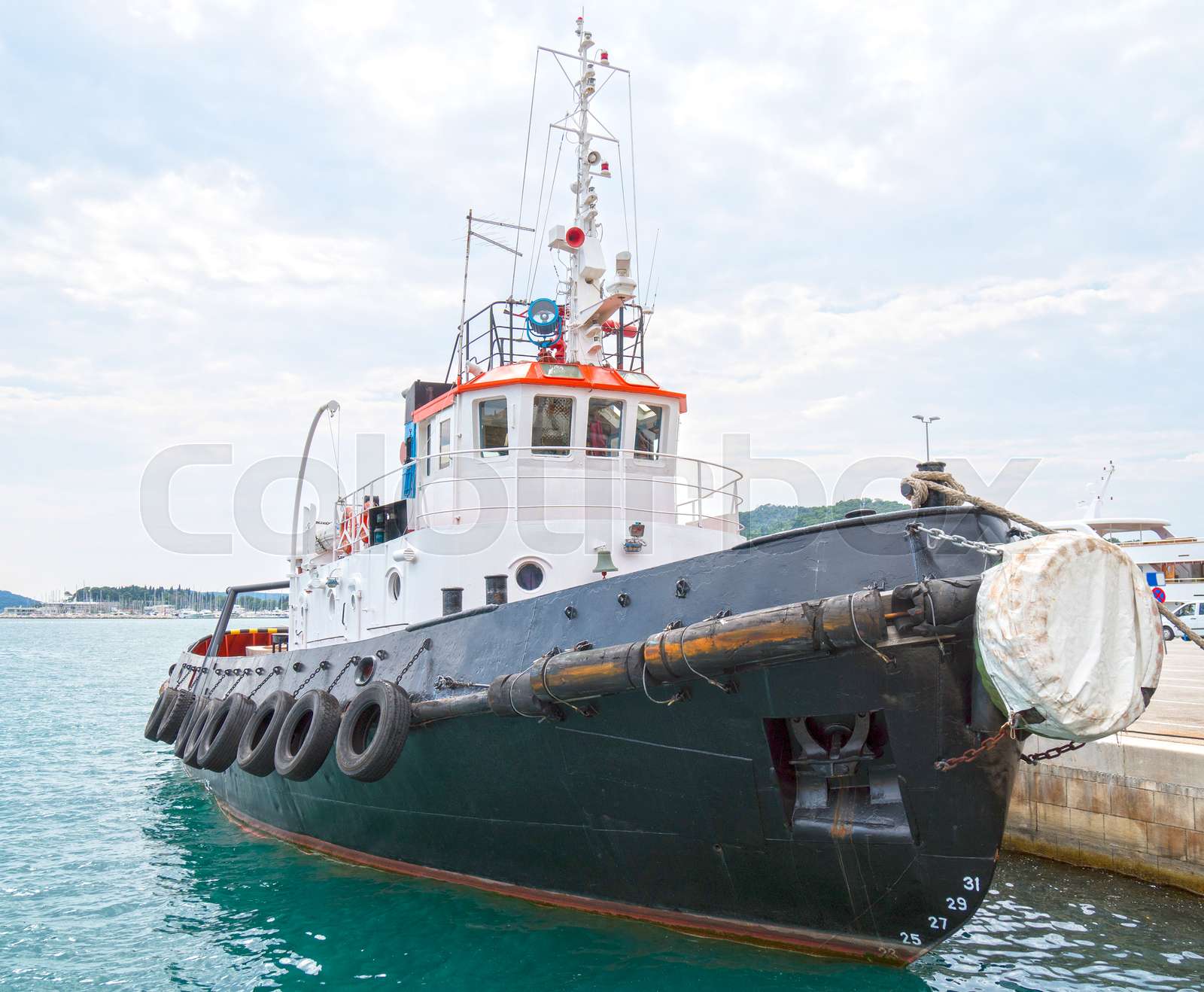 Black tugboat moored in the sea port. | Stock image | Colourbox