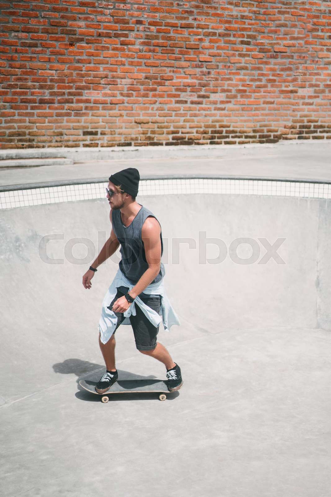 handsome sportive man skating at skatepark | Stock image | Colourbox