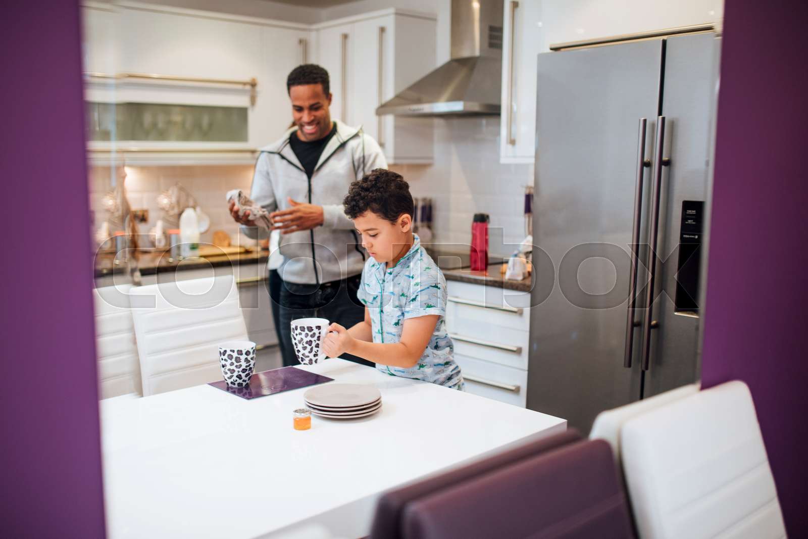 Helping Dad set the Table for Breakfast | Stock image | Colourbox