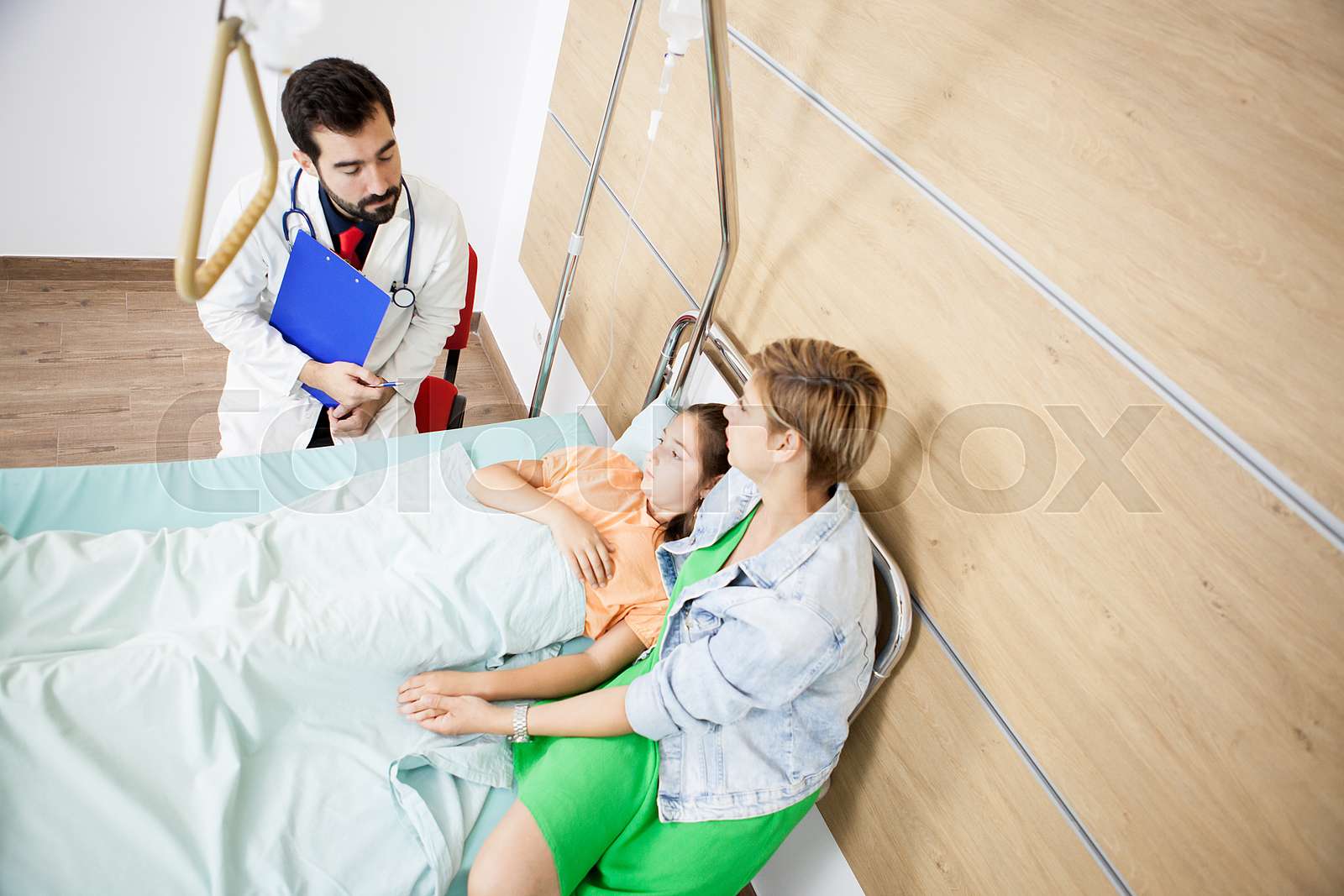 Doctor giving the news to patient girl and mother | Stock image | Colourbox