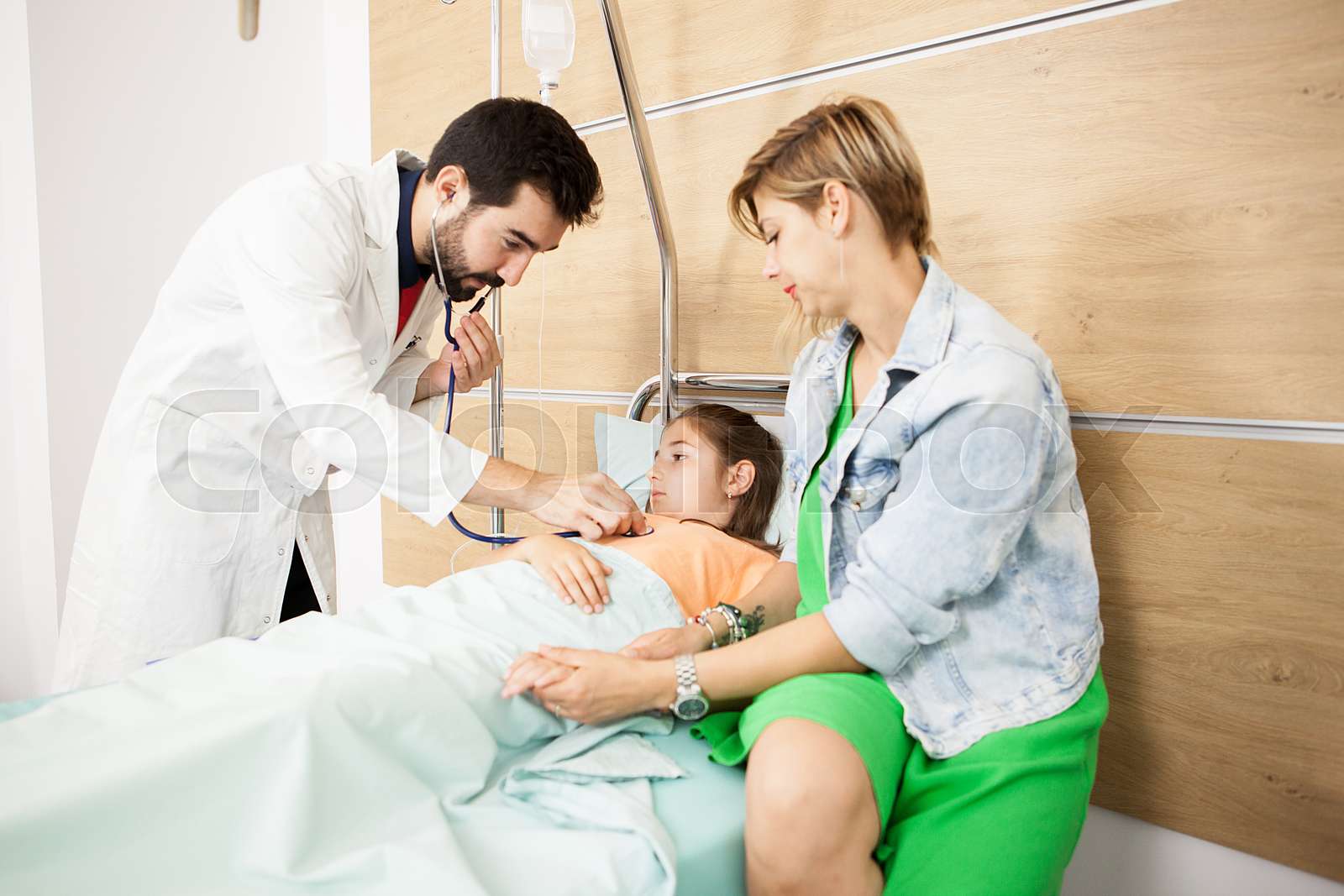 Doctor checking her patient heart | Stock image | Colourbox