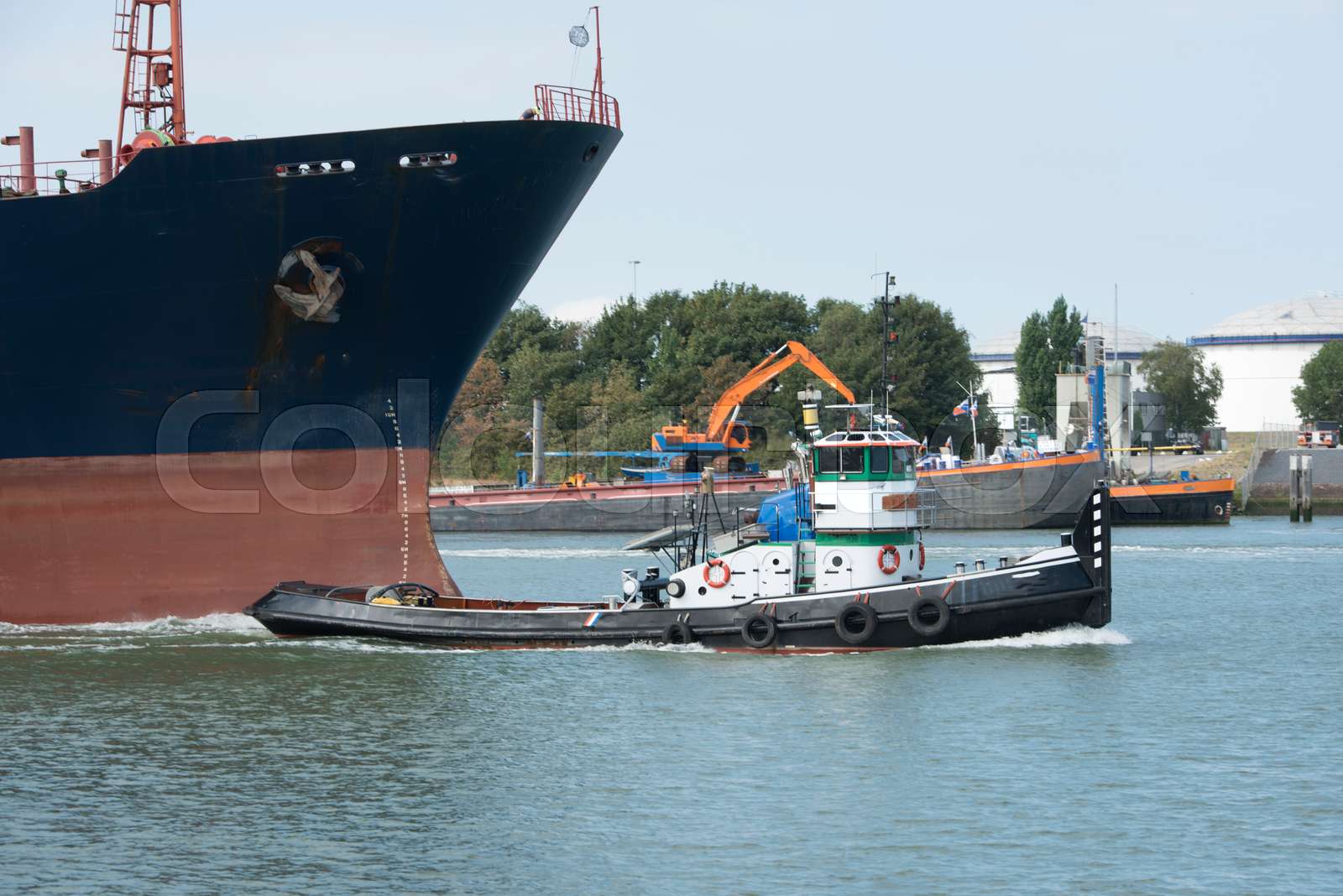 small tug boat pulling big ship | Stock image | Colourbox