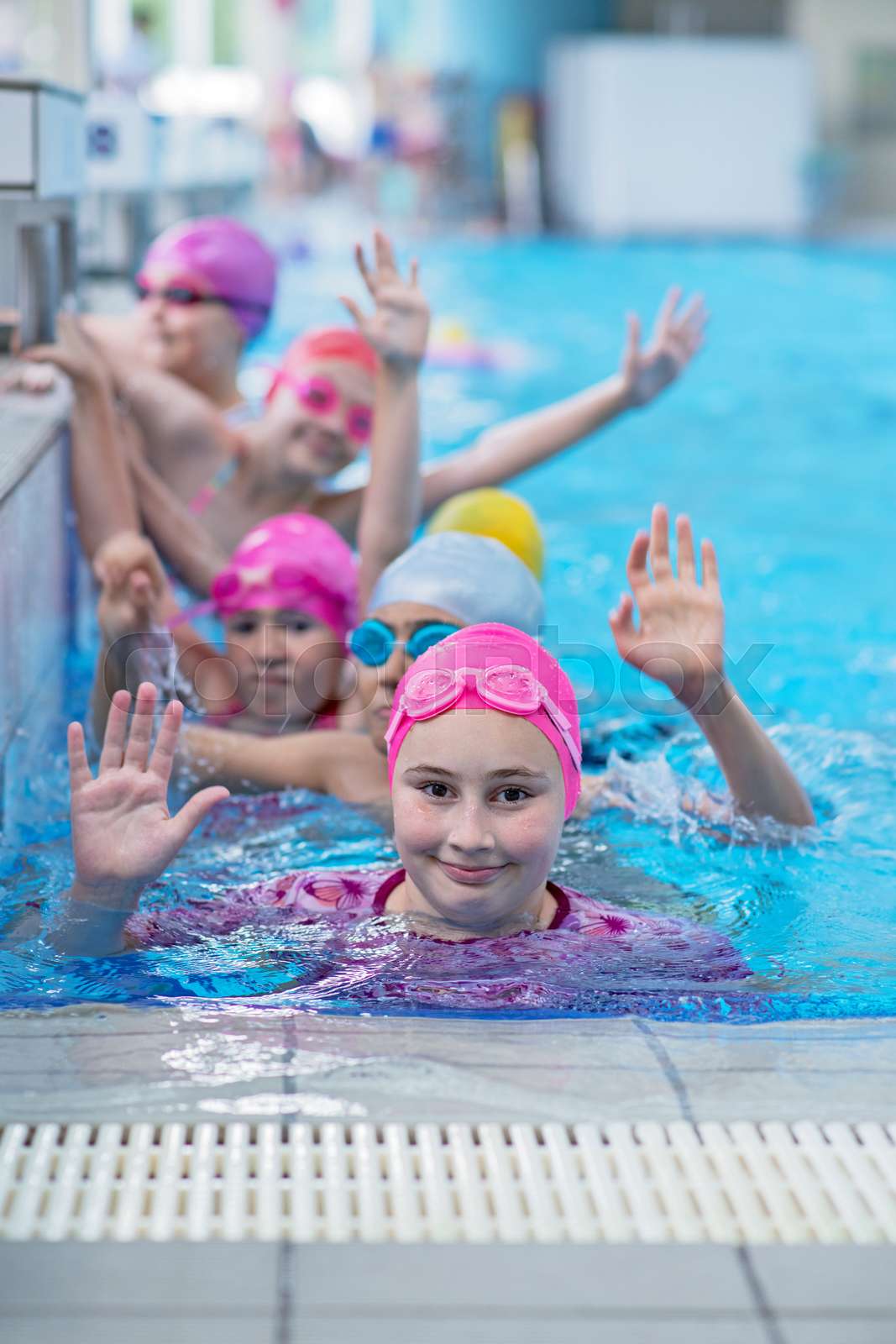 happy kids at the swimming pool. young and successful swimmers pose ...