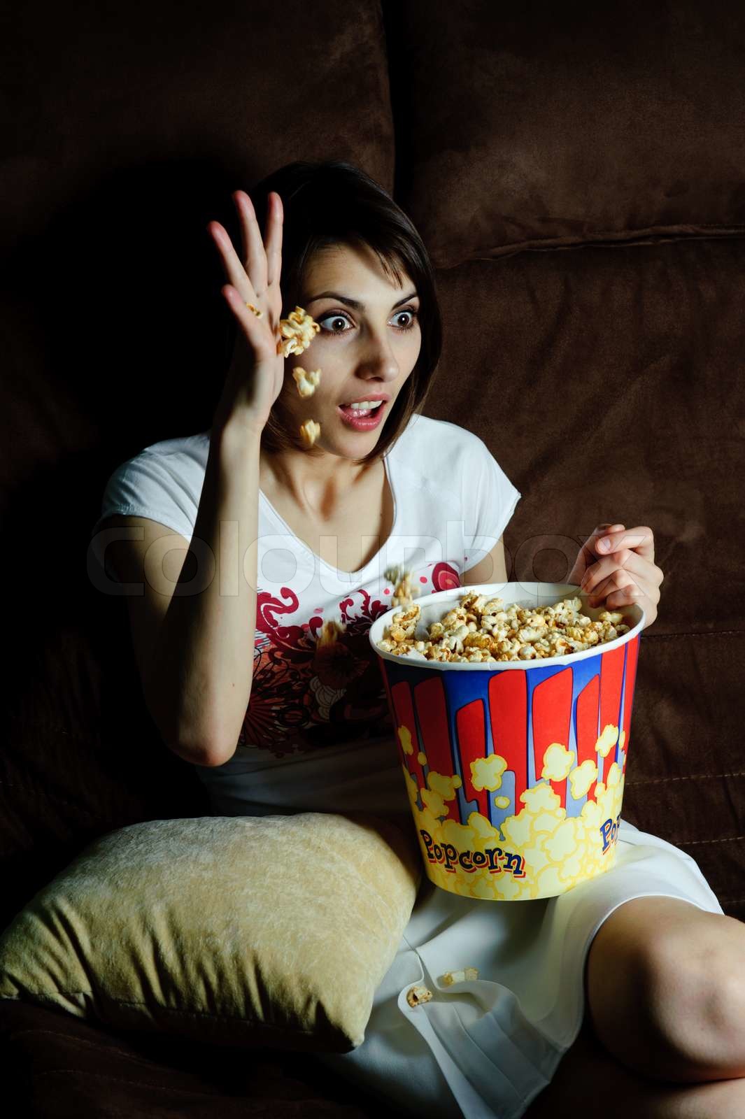 An image of woman watching TV with popcorn | Stock image | Colourbox