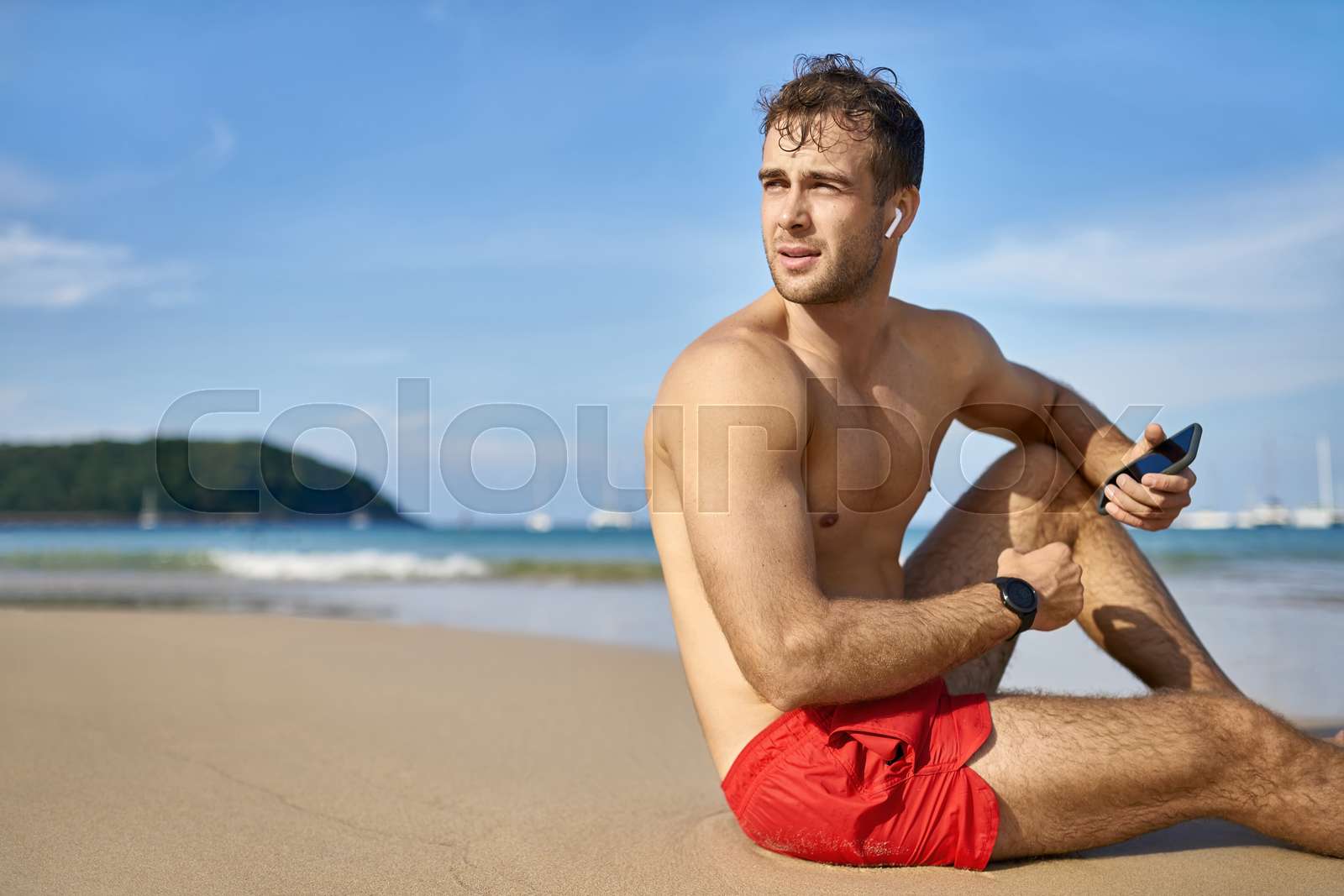 Tanned guy on beach | Stock image | Colourbox