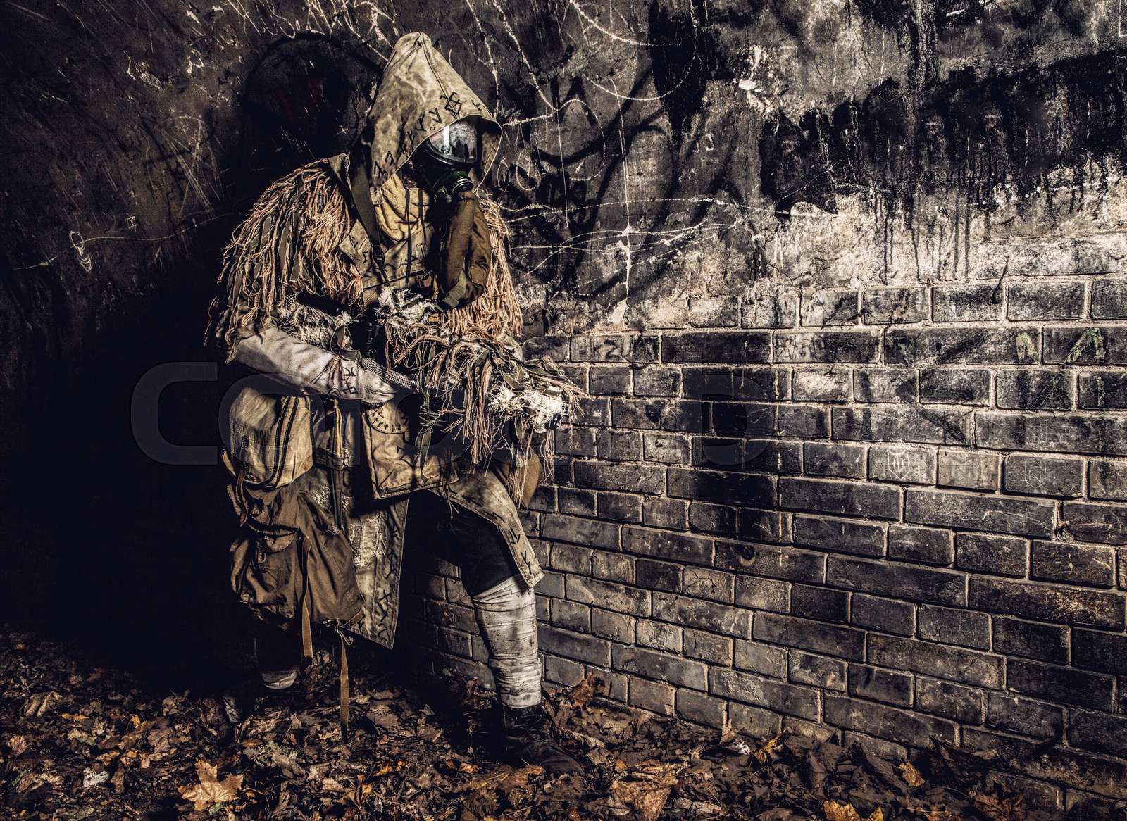 Post apocalyptic creature in gas mask armed gun | Stock image | Colourbox