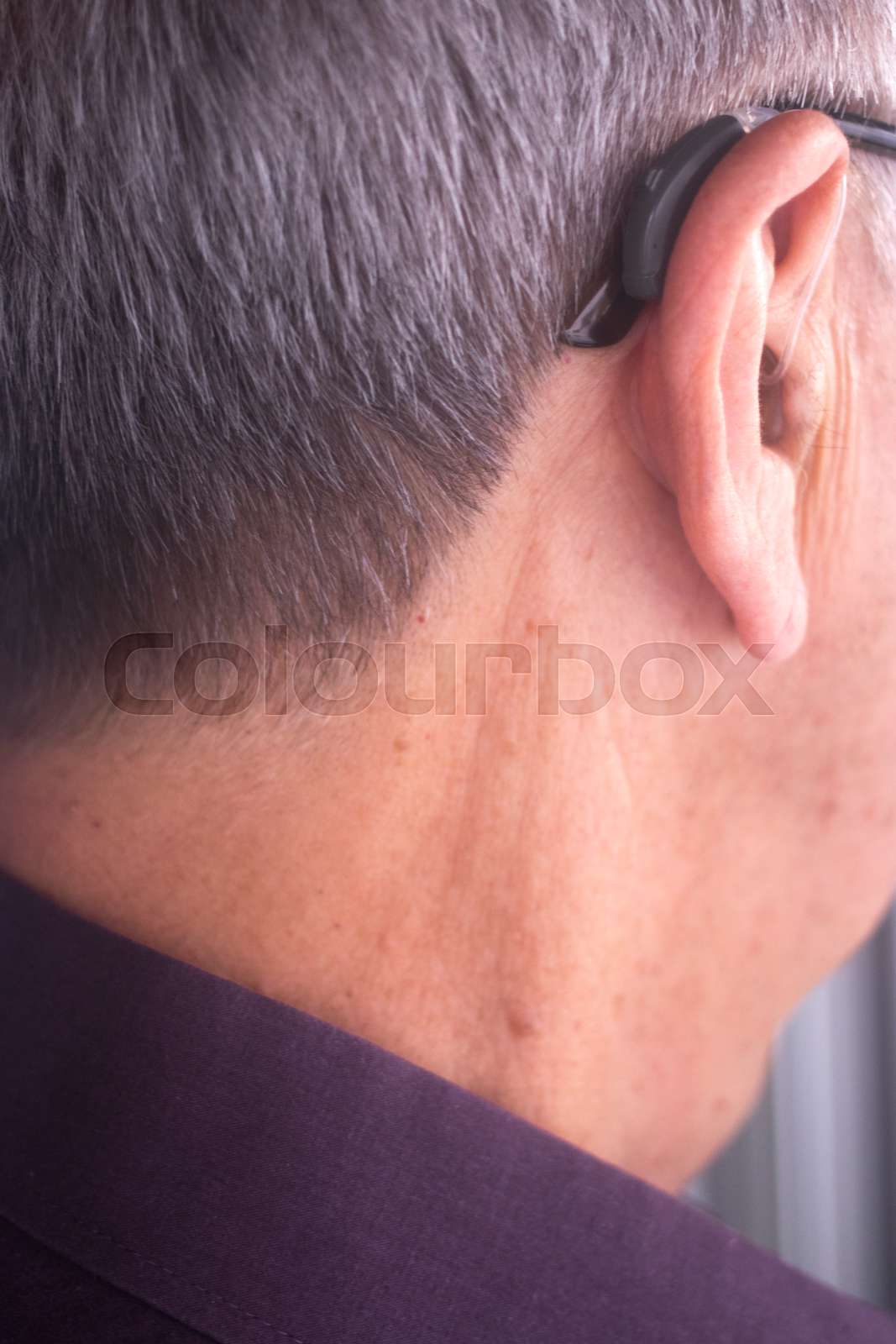 Deaf man hearing aid ear | Stock image | Colourbox