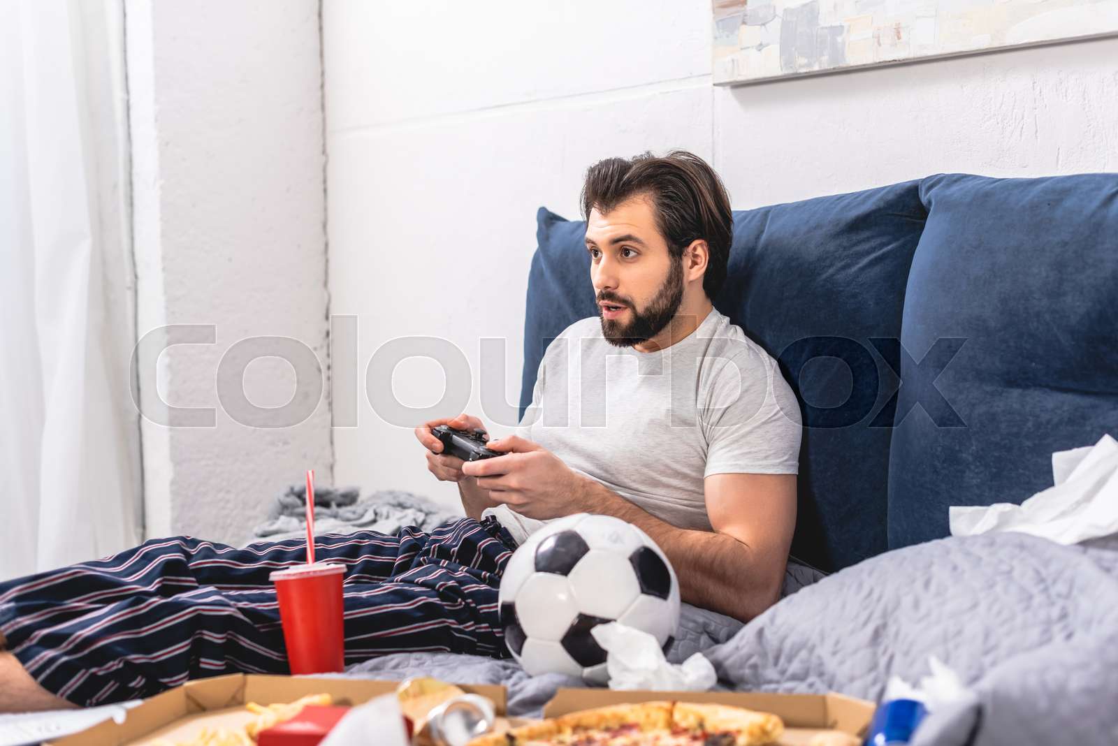 male loner playing video game in bedroom | Stock image | Colourbox