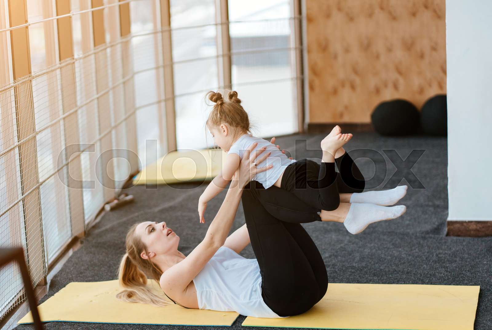 Mom and daughter together perform different exercises | Stock image ...