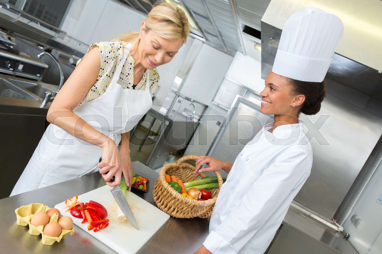 Female chefs prepping vegetables | Stock image | Colourbox